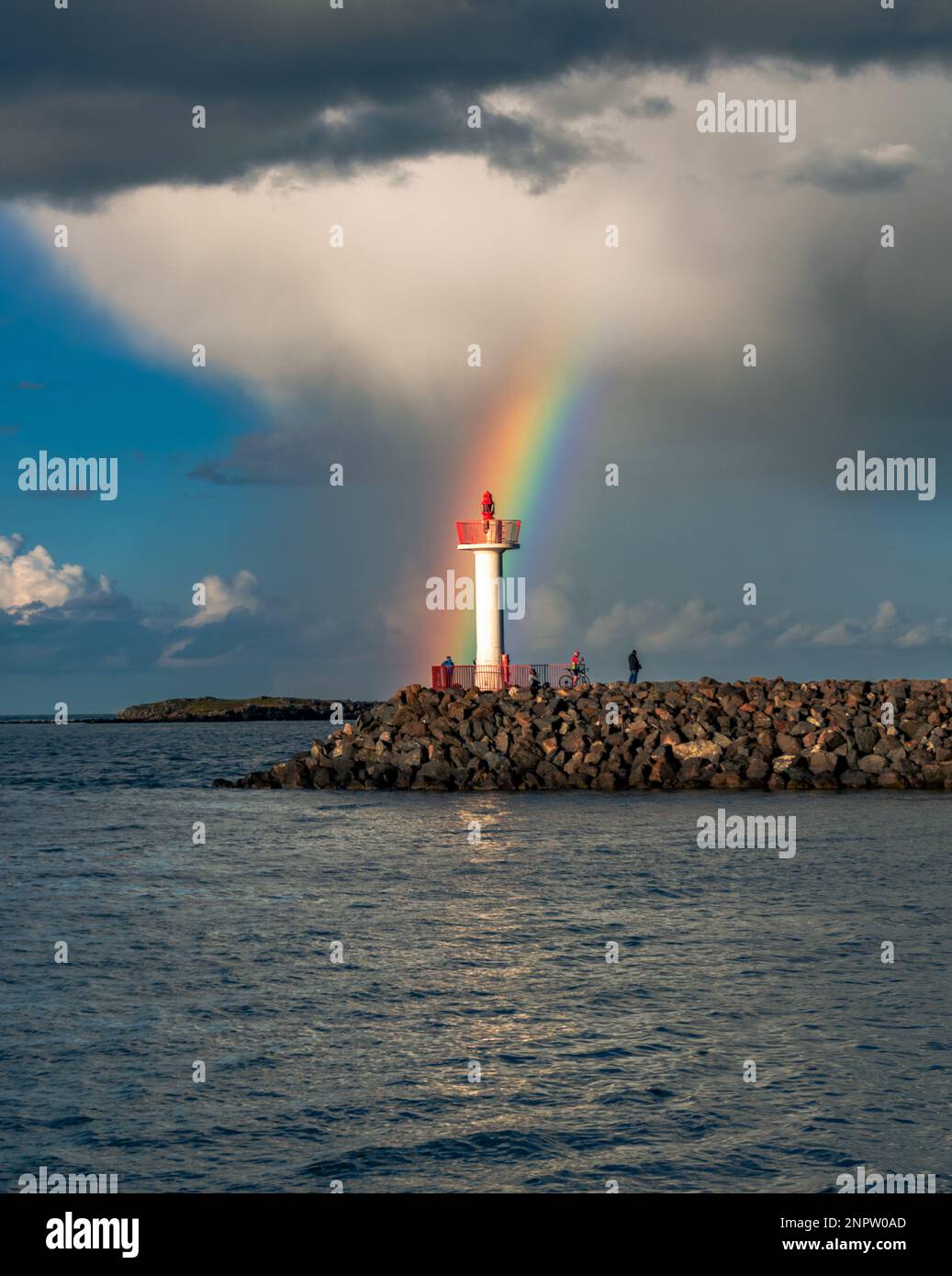 The end of a rainbow lined up with Howth Lighthouse Stock Photo - Alamy