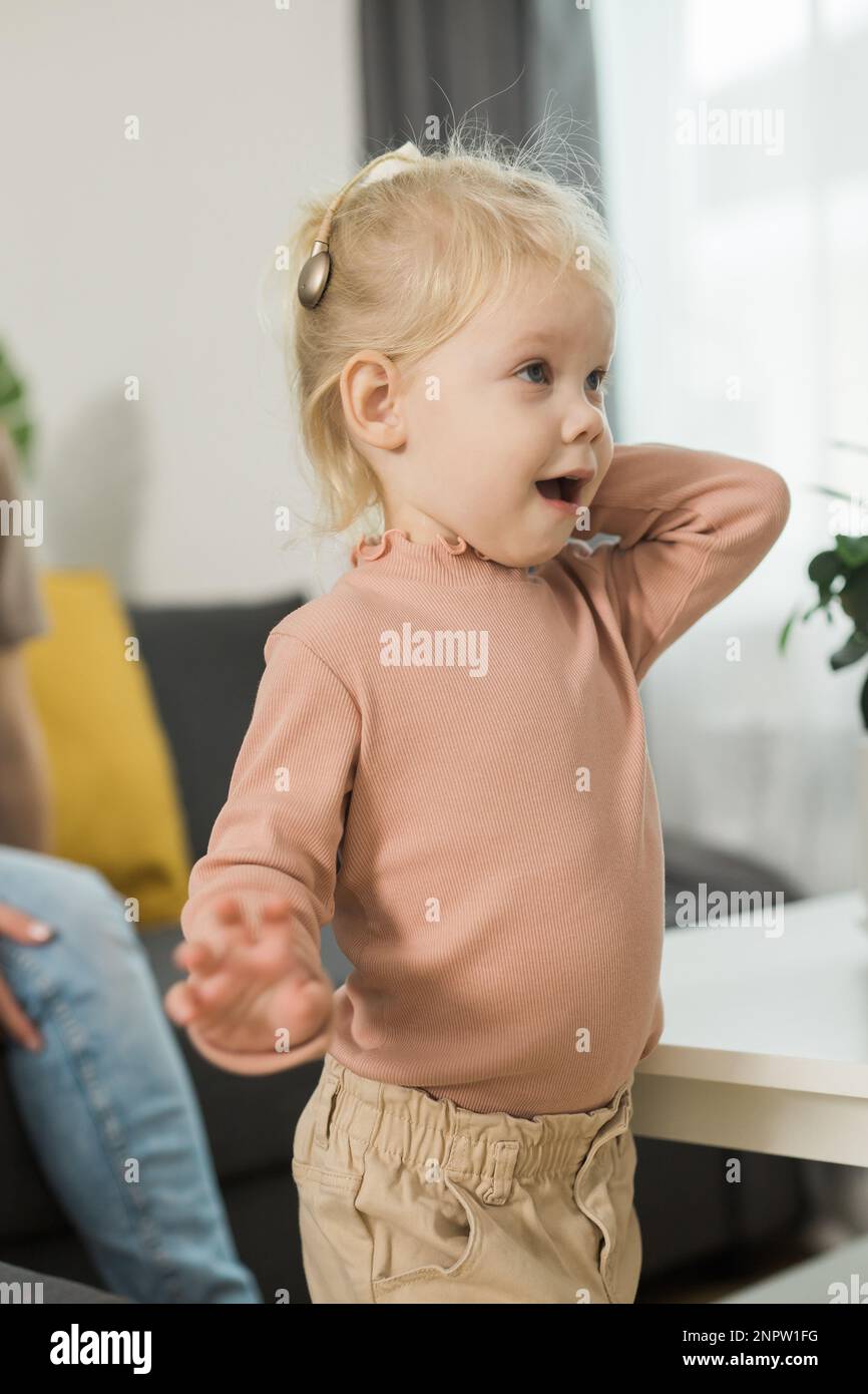 Cochlear implant system. Installation cochlear implant on child girl ...