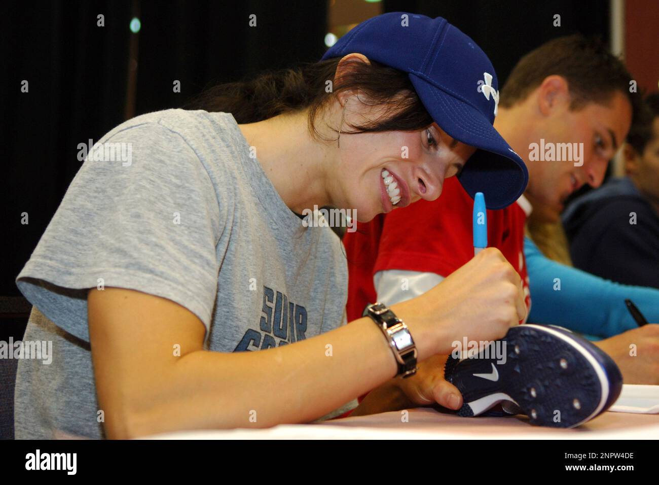 Jennifer Stuczynski signs her autograph on a track spike during the UCS ...