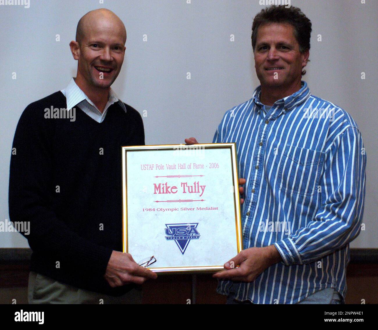 Millikan High graduate Mike Tully (right) is presented with plaque by ...