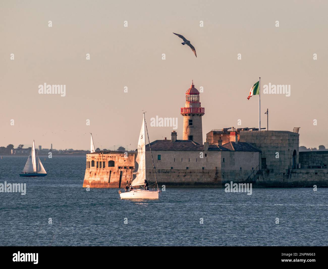 Boats passing by Dún Laoghaire Lighthouse on a fine August evening ...