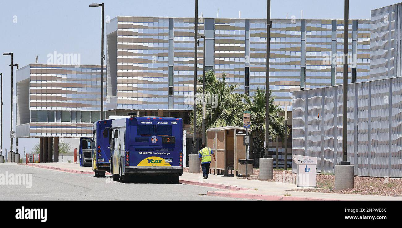 Two Yuma County Area Transit (YCAT) buses wait in the loading and ...