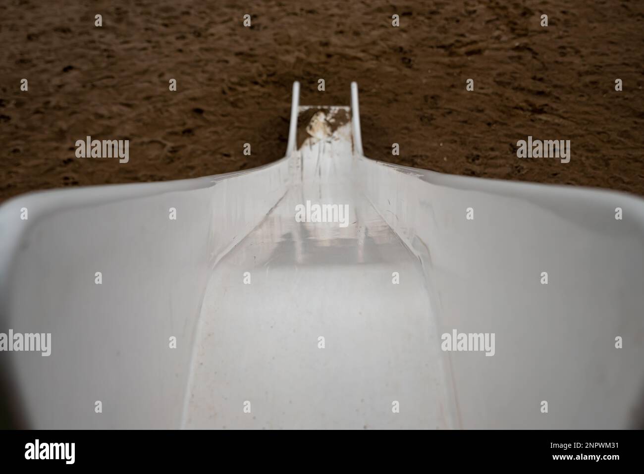 white slide top shot , white slide in children's playground on sand ...