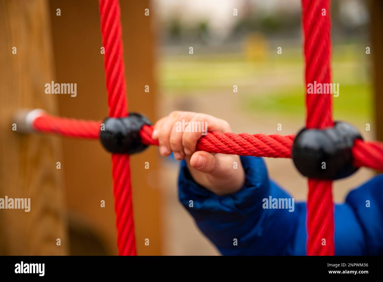 climbing net in children's playground , red rope Childrens playground in the city park. , . High ...