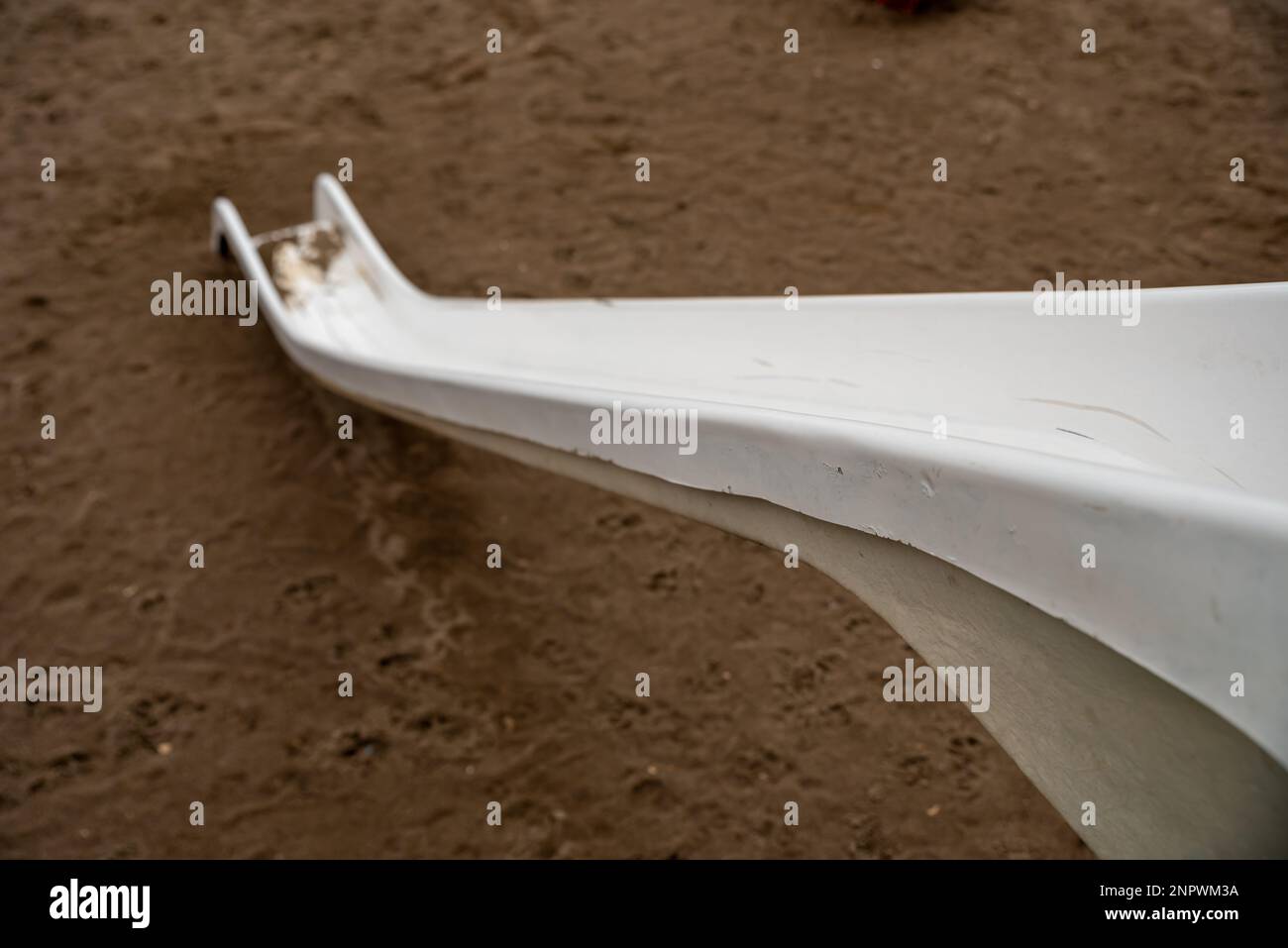 white slide top shot , white slide in children's playground on sand ...