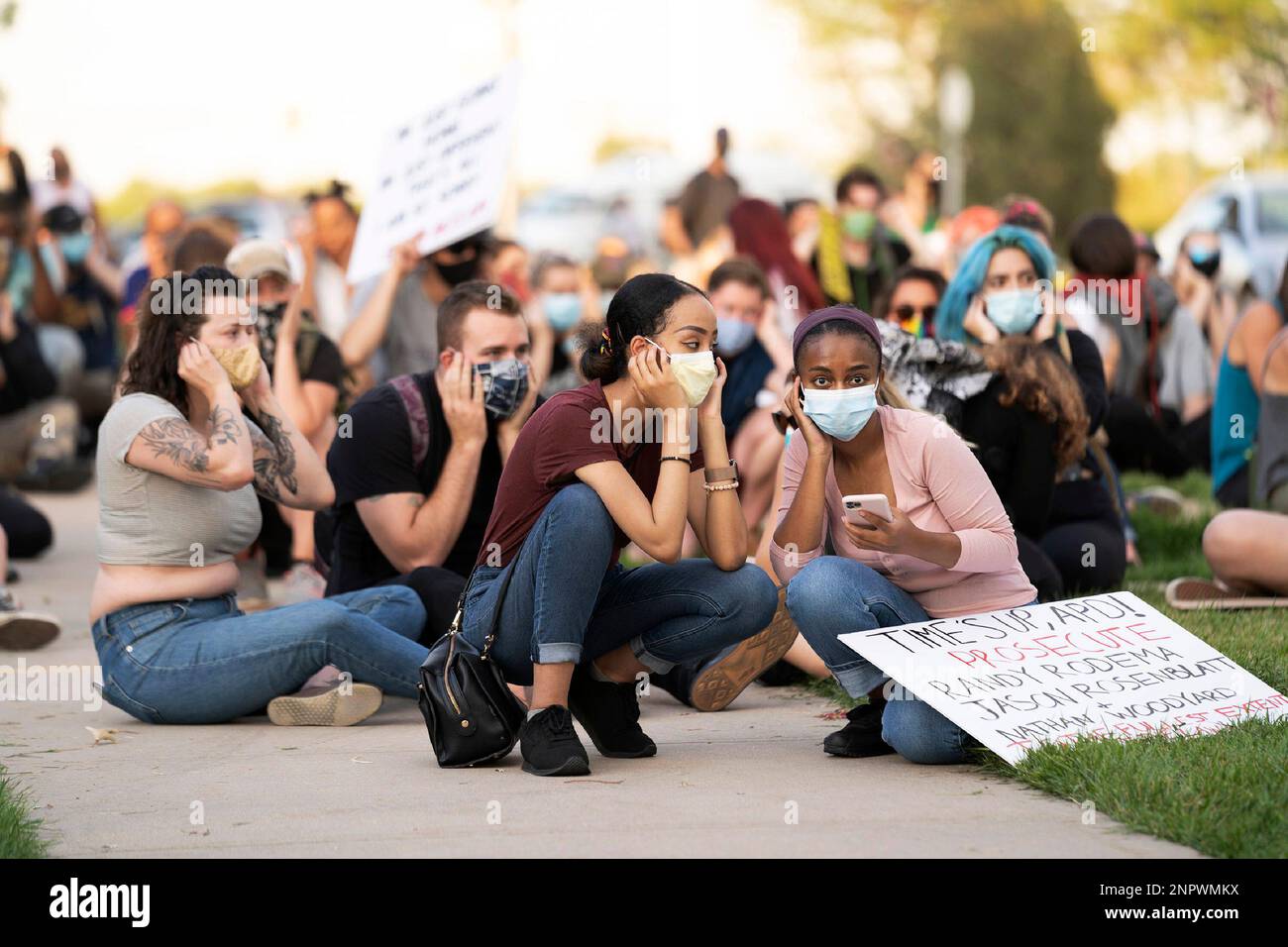 Demonstrators cover their ears as they expect the deployment of a long ...