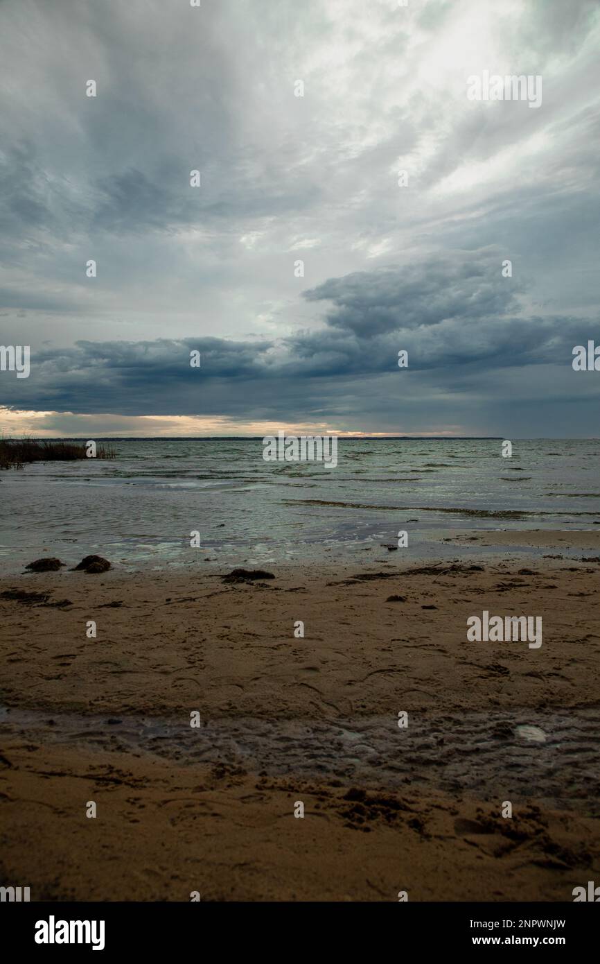 Beautiful Cloudy Sky Over Shell Covered Beach Stock Photo - Alamy