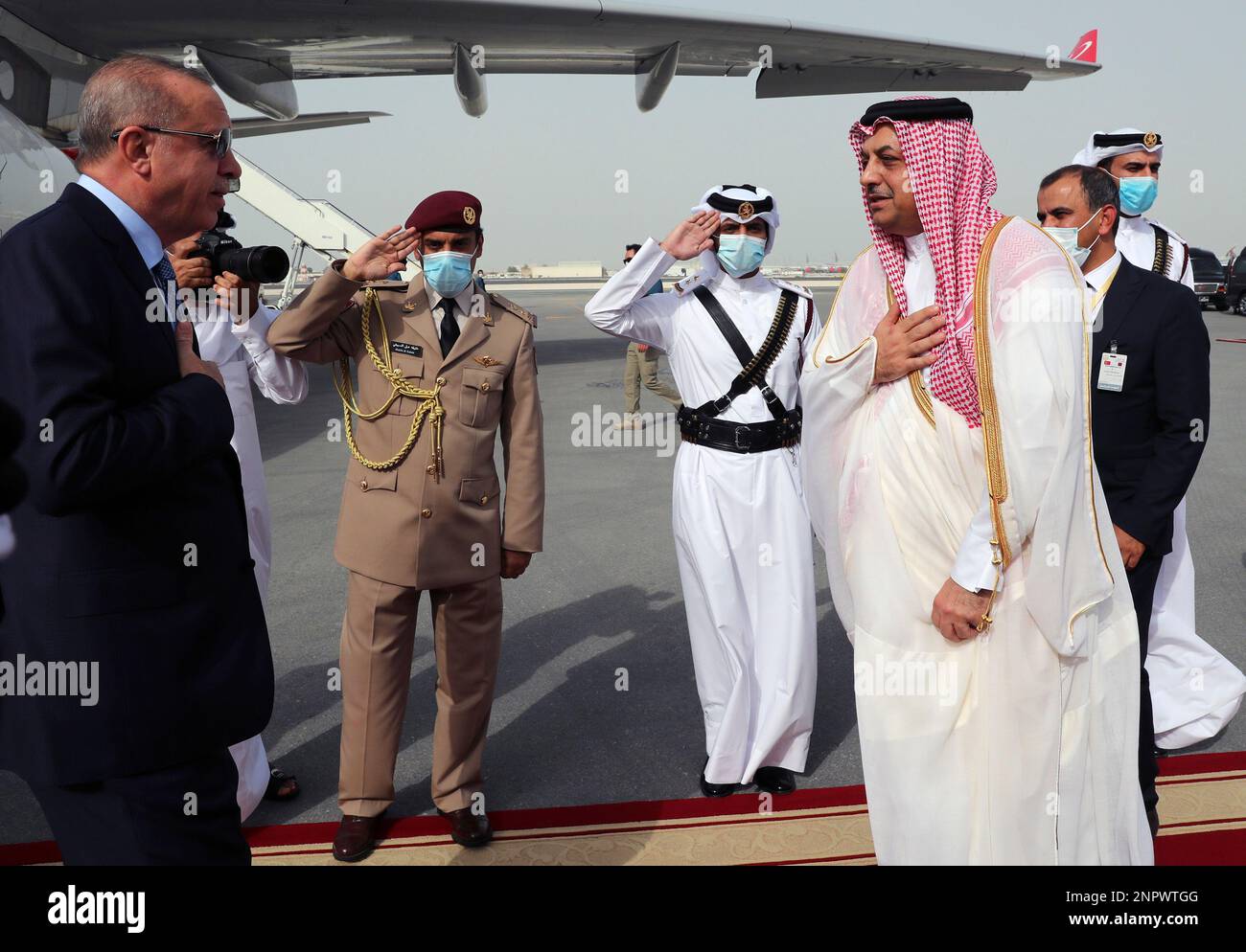 Turkey's President Recep Tayyip Erdogan, left, and Qatari officials ...