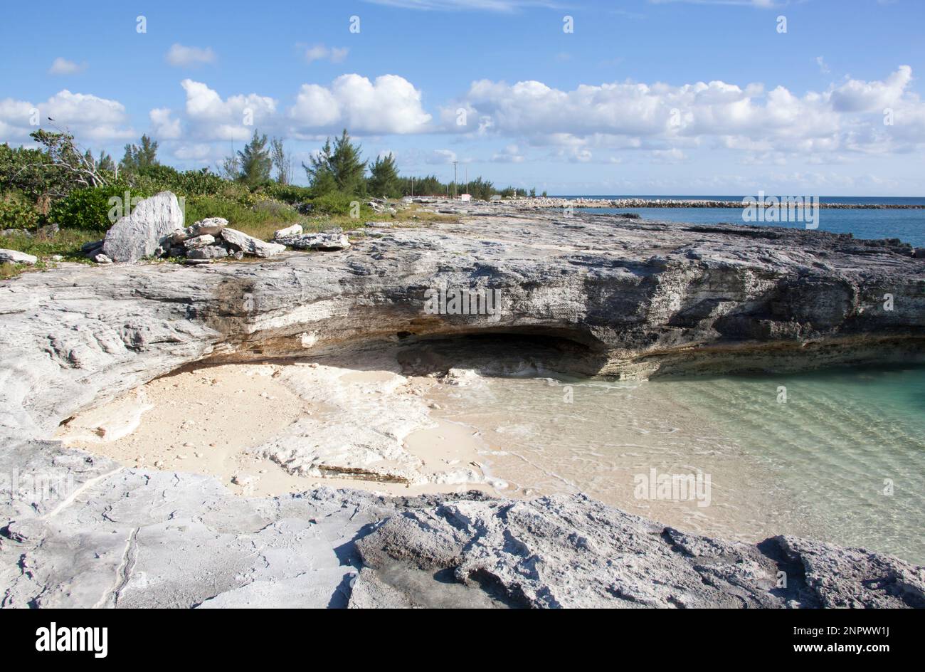 The scenic view of a small beach surrounded by eroded coastline on ...