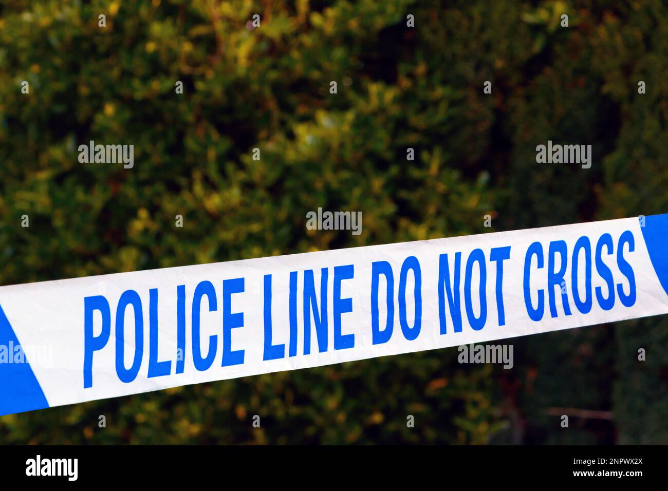 close up of police line do not cross tape at cordon around crime scene ...