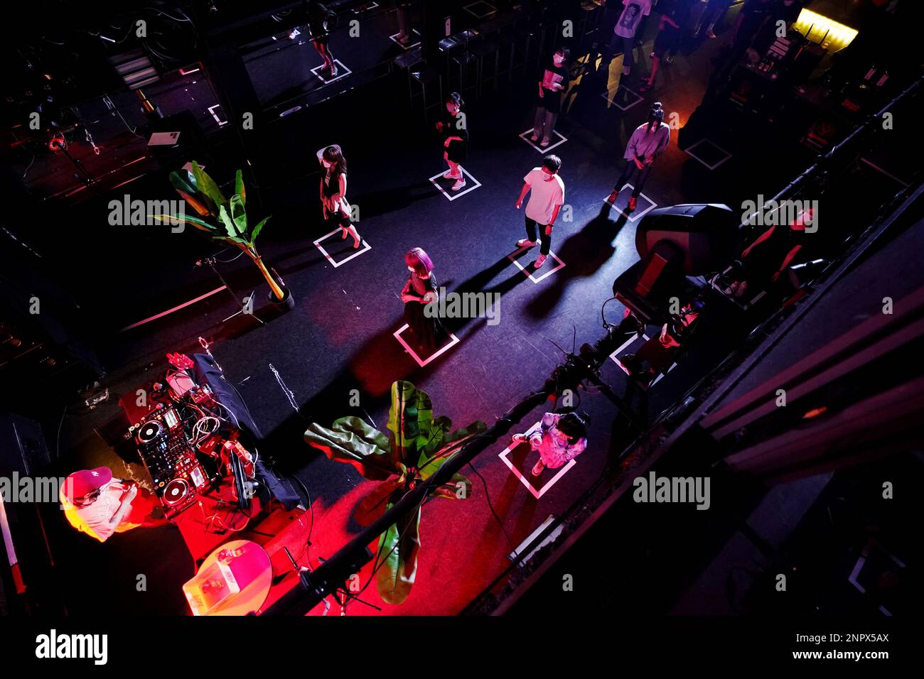 Young people wearing face mask dance inside of adhesive tape on the ...