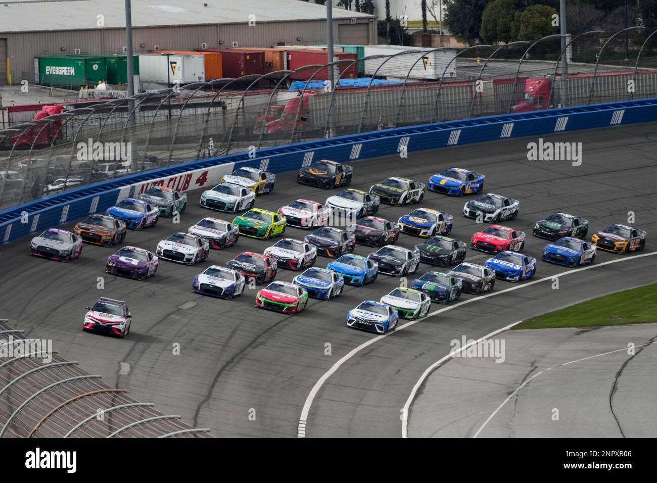 Cars drive in a five-line formation to acknowledge the fans before a ...