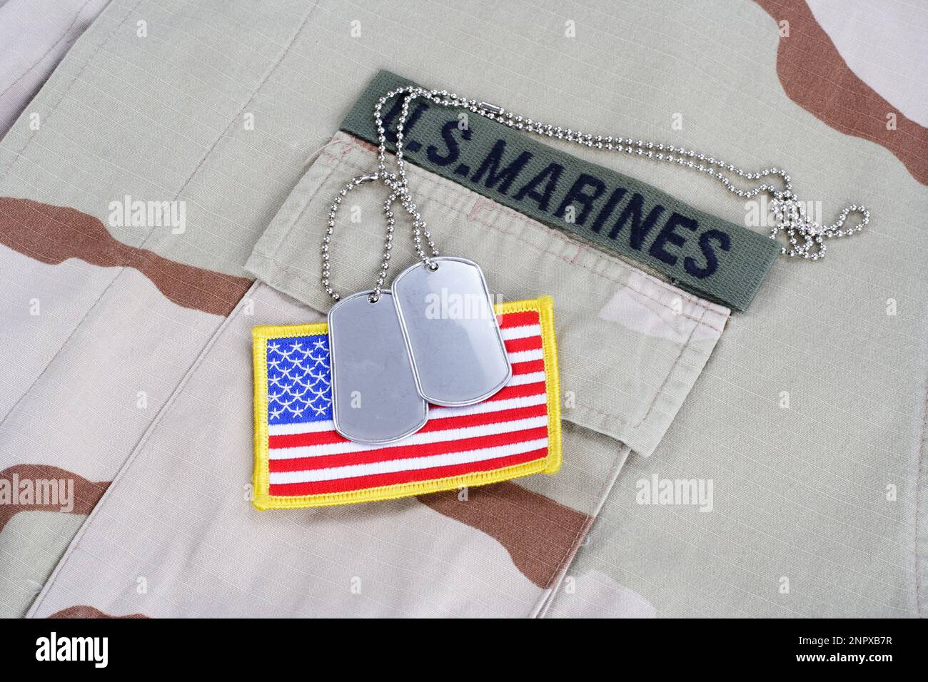 US MARINES branch tape with dog tags and flag patch on desert ...