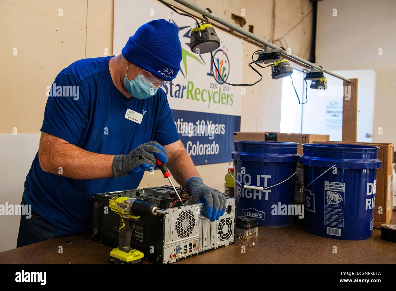 Blue Star Recyclers' Danny Hennessy takes apart a desktop computer at ...