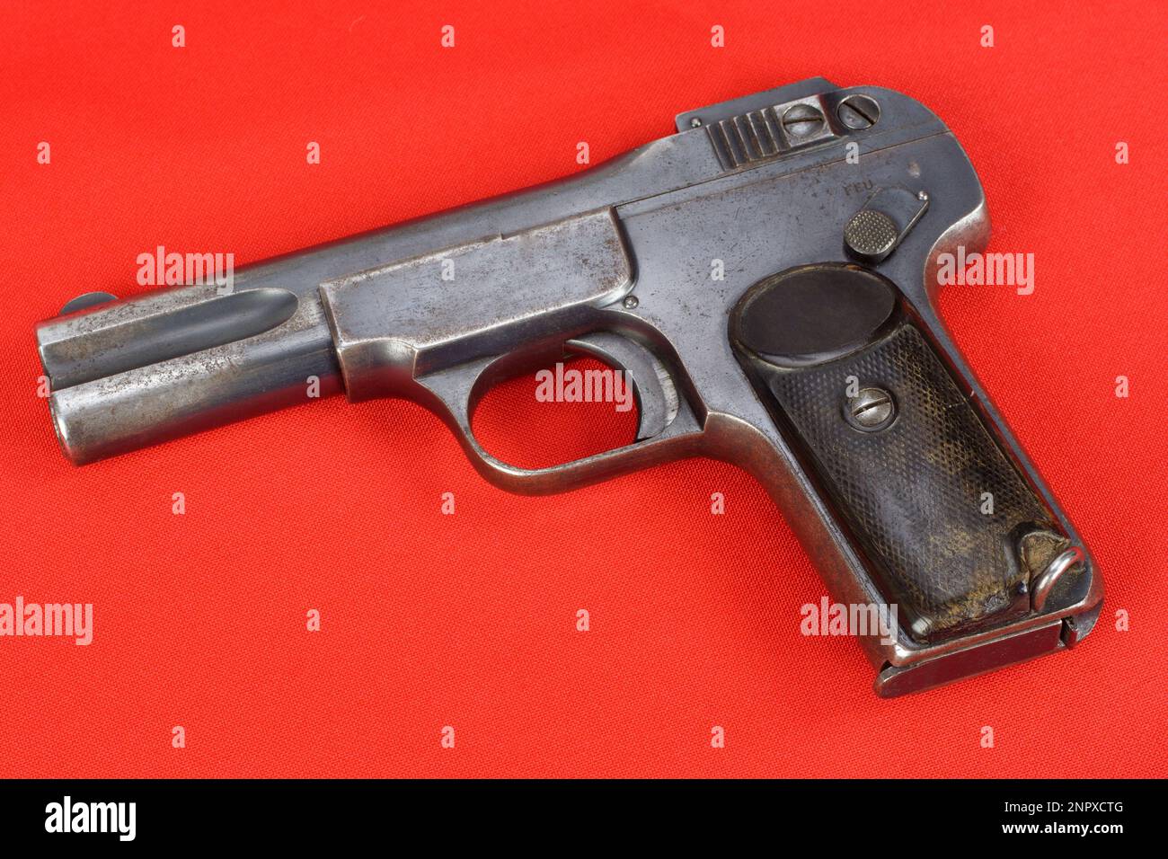 Antique rusty handgun on red background Stock Photo - Alamy