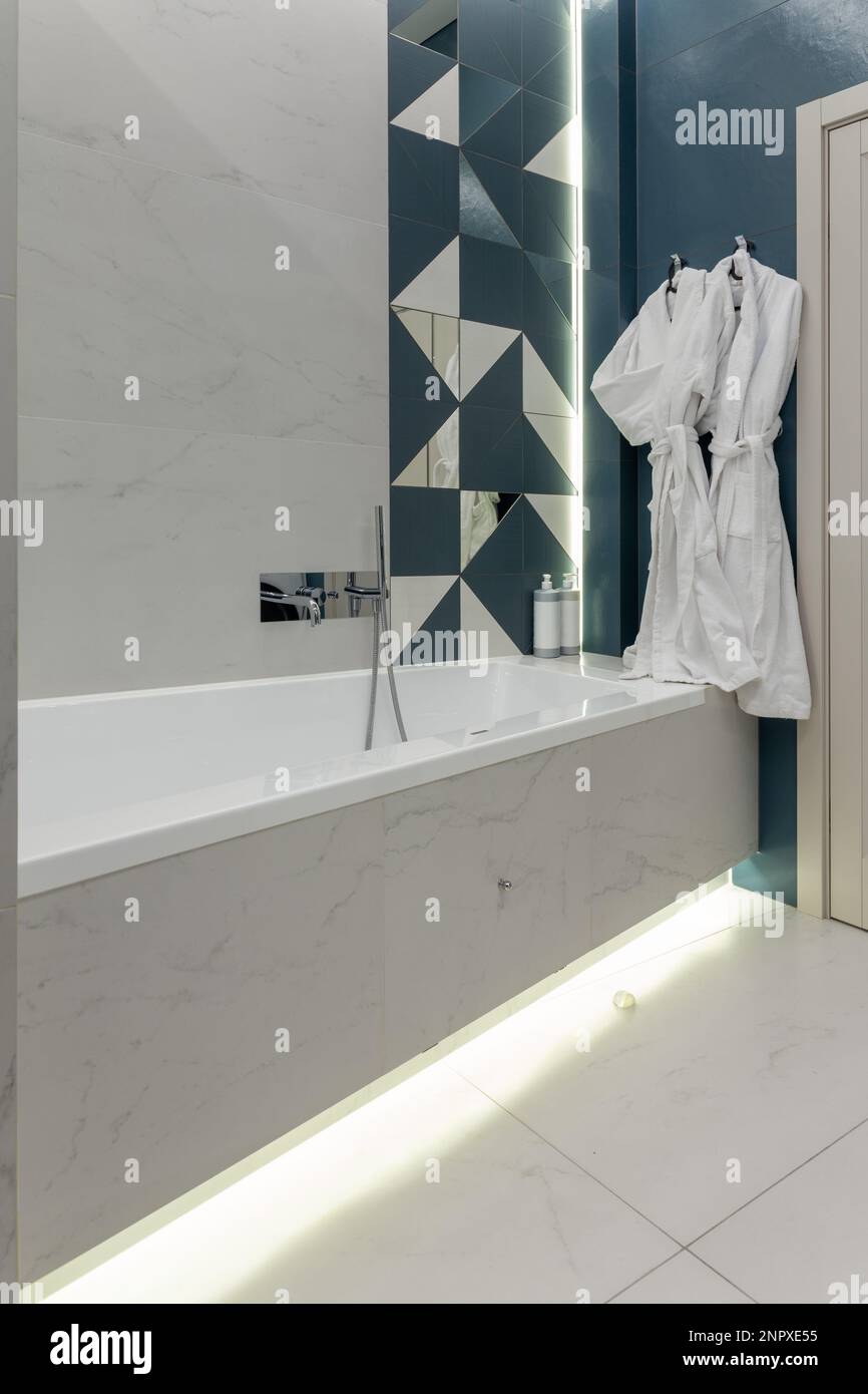 Detail of the bath tub in bathroom. Luxury blue and white bathroom with ...
