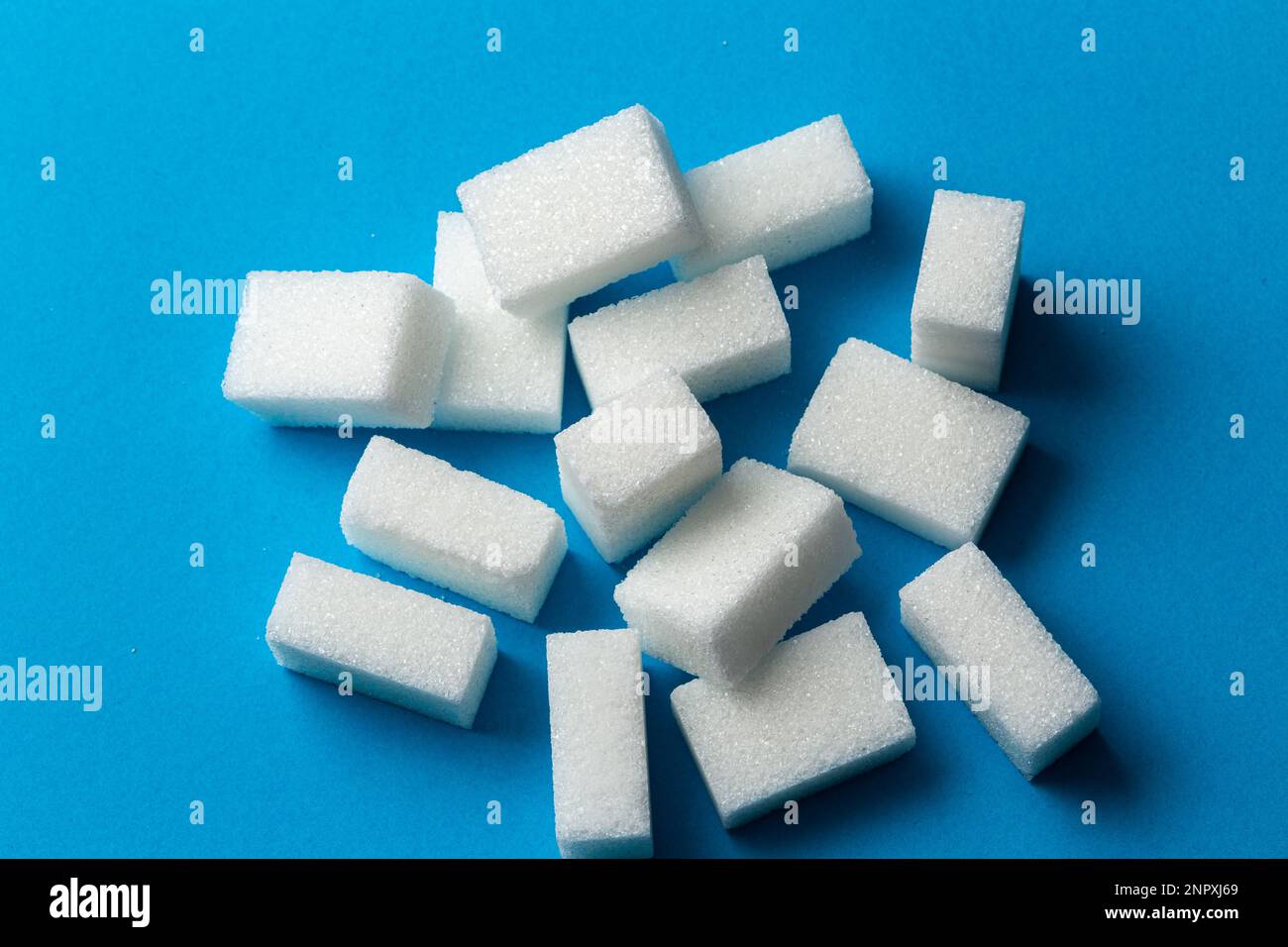 Sweet and Simple: White Sugar Cubes on a Blue Background Stock Photo ...