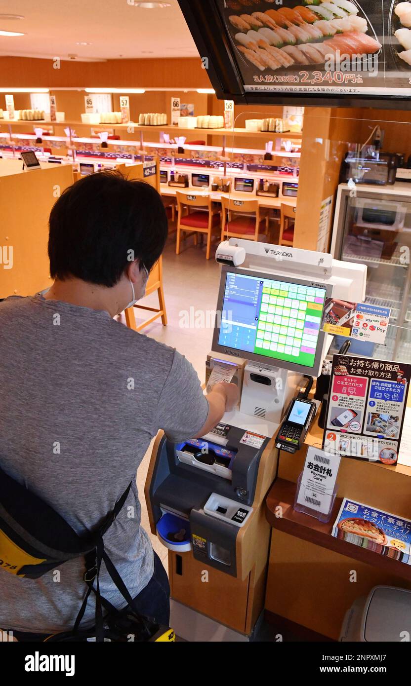 Self-checkout machines are installed at a sushi restaurant, Sushiro, in ...