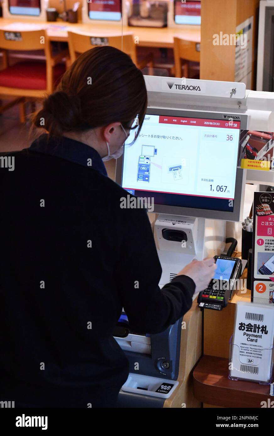 Self-checkout machines are installed at a sushi restaurant, Sushiro, in ...