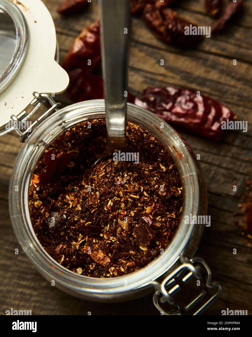 Roasted dry chili pepper powder in jar. Dried chilli on background. Top ...