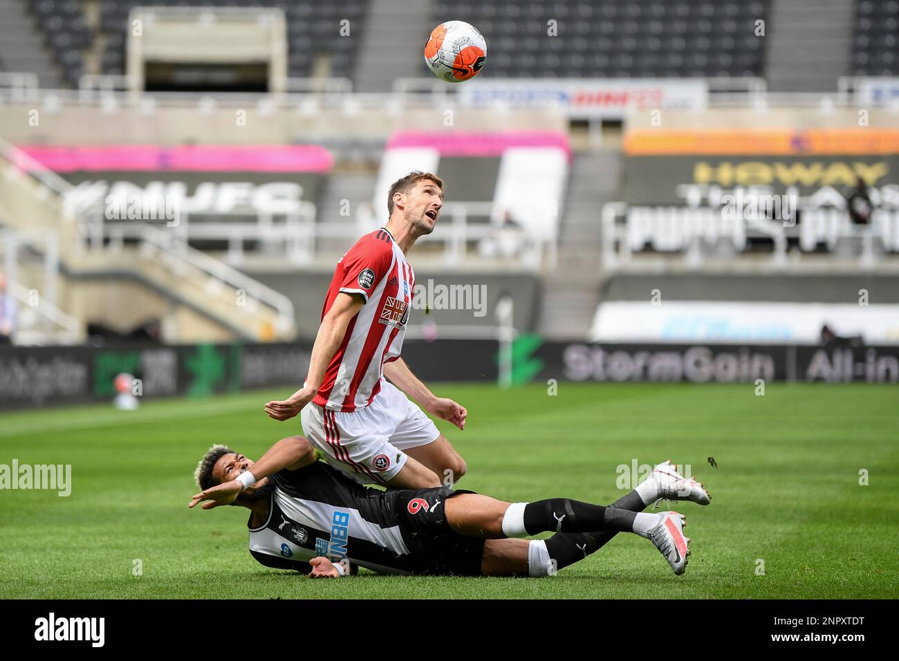 Newcastle's Joelinton, bottom, and Sheffield United's Chris Basham duel ...