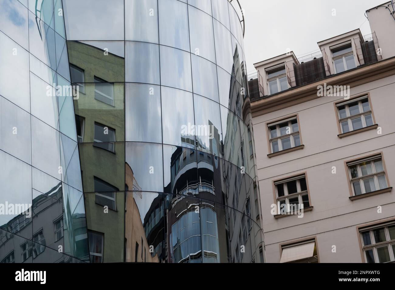 a European architecture reflecting in the mirror glass facade of a ...