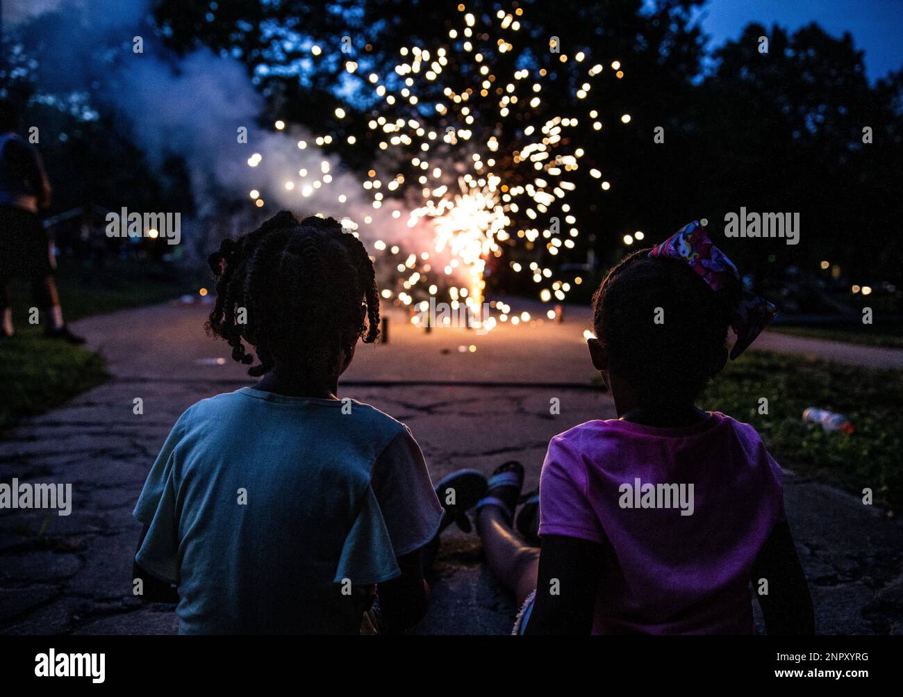 Two little girls watch fireworks during a Juneteenth celebration at ...