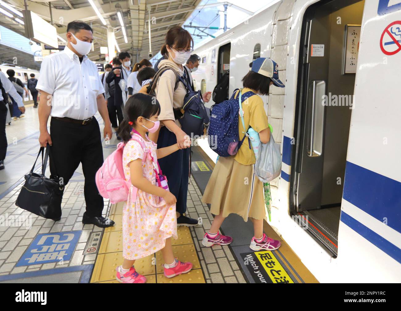 Passengers wearing masks are seen at the Shinkansen Bullet train ...