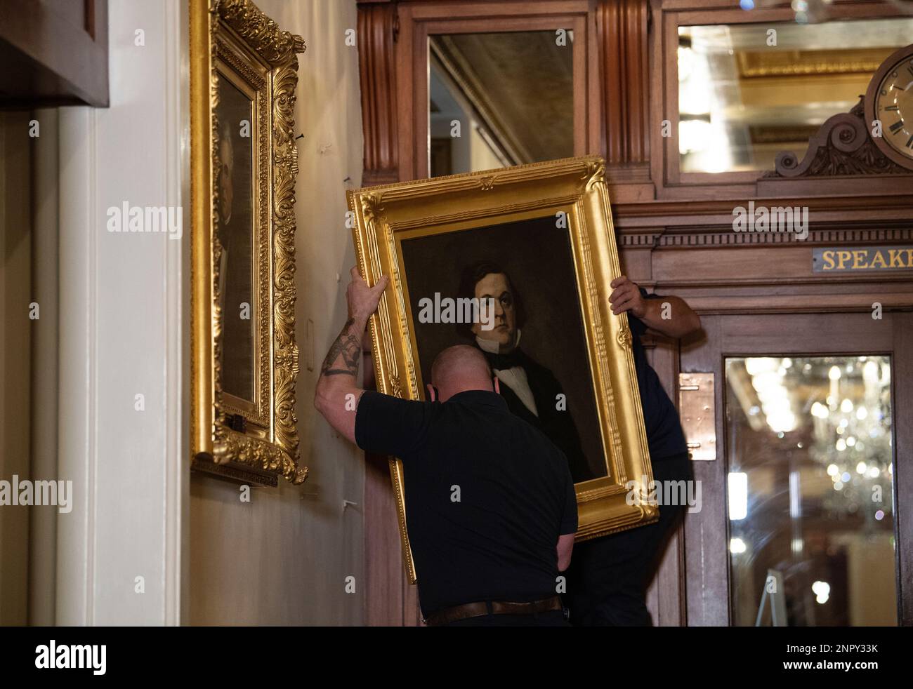 Architect of the Capitol workers remove a portrait of Howell Cobb of ...