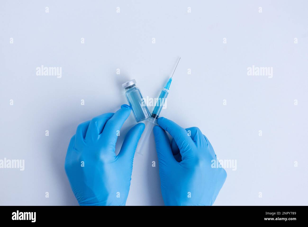 On white isolated background, the hands of doctor in medical blue ...