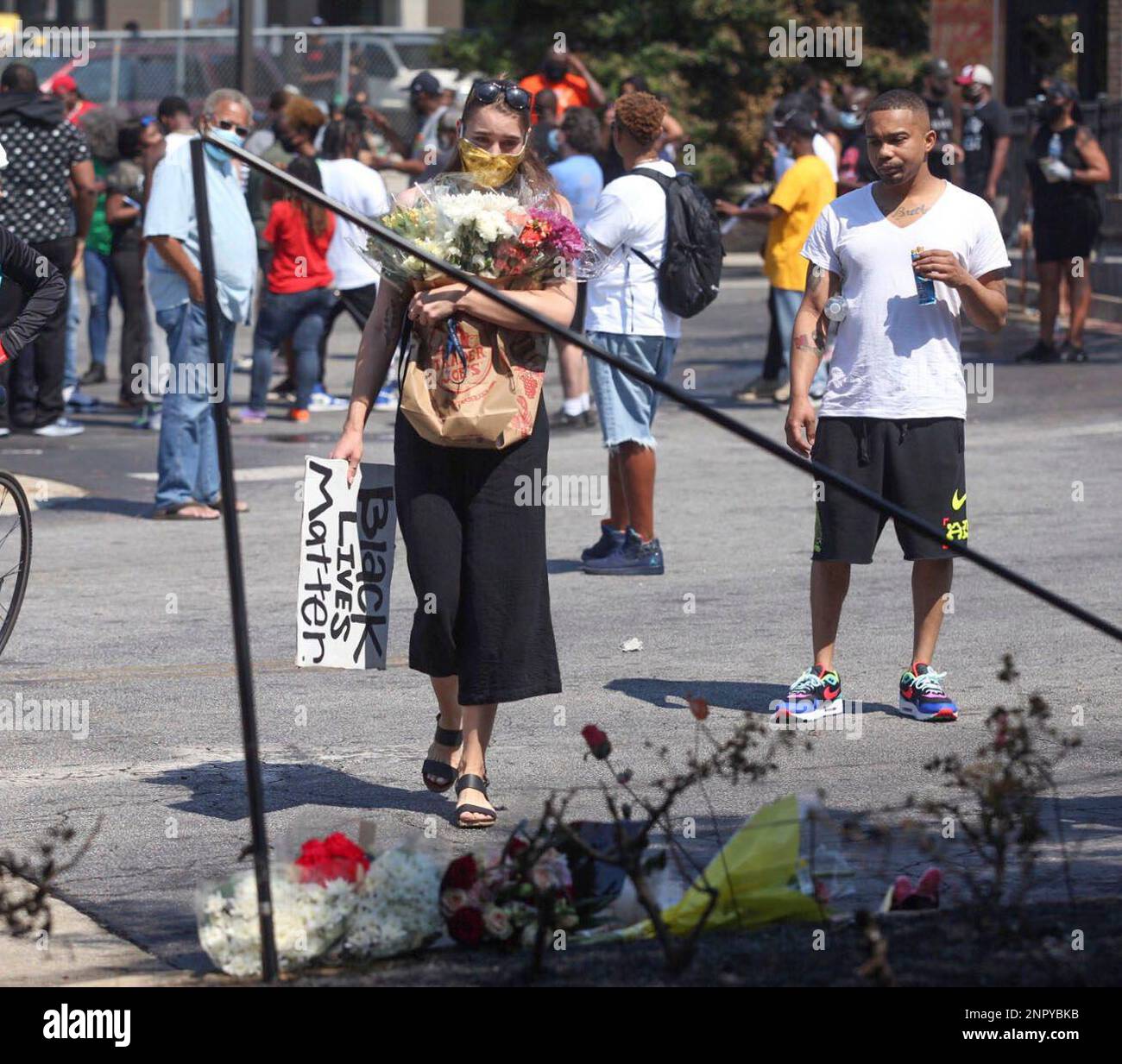 Natalie Olsen lays flowers at the memorial in the Wendy's parking lot ...