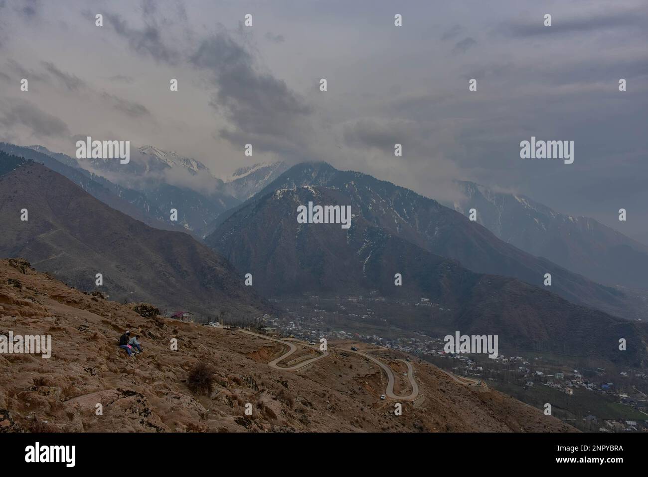 Srinagar, India. 26th Feb, 2023. Visitors rest on top of the hill ...