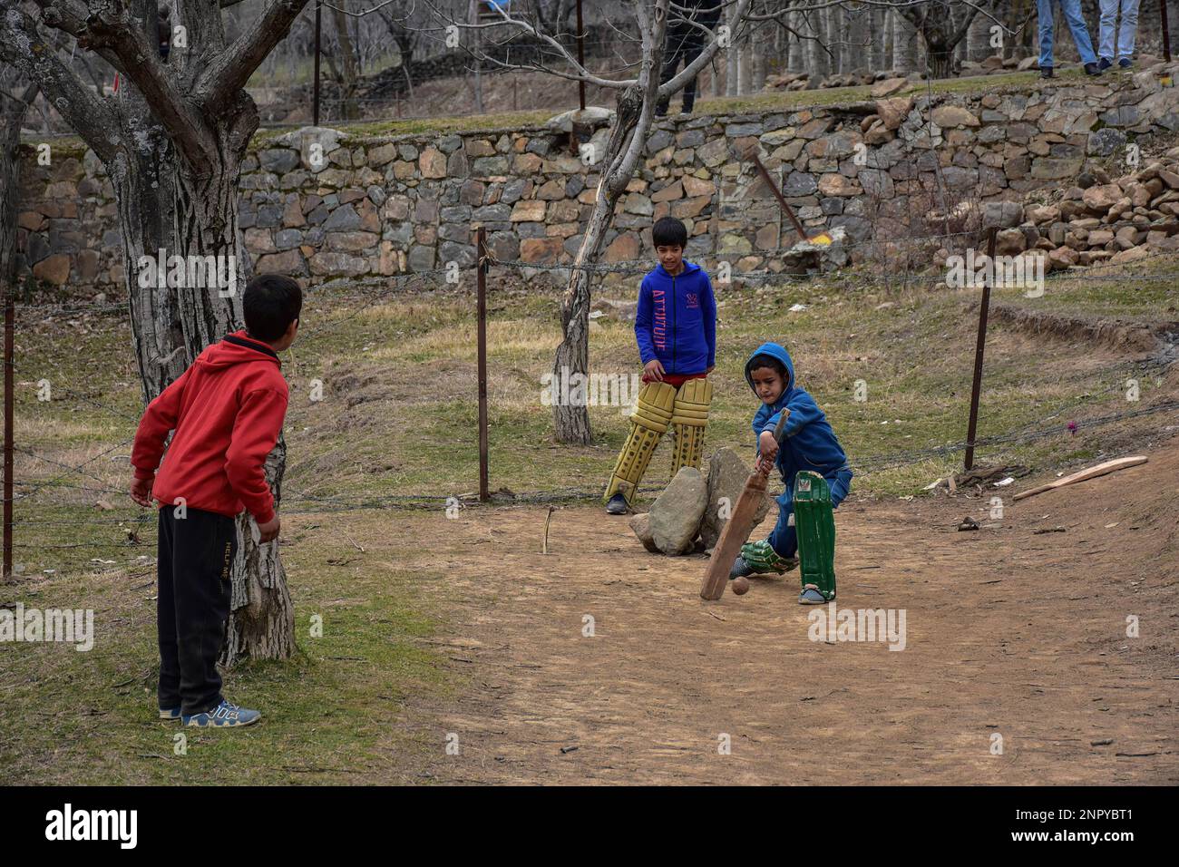 Boys play cricket during a cloudy winter day in Astanmarg, about 30kms ...