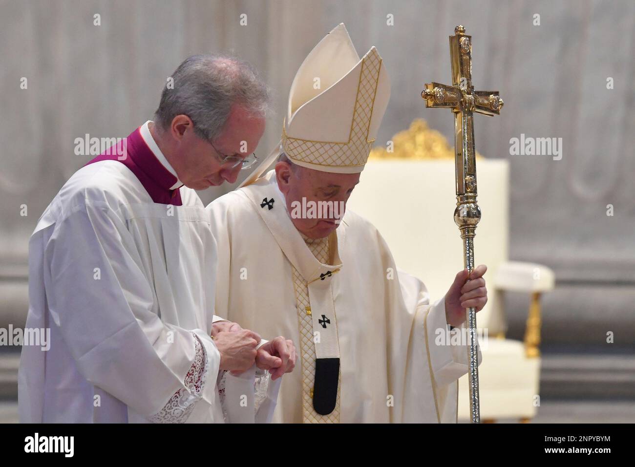 Pope Francis leaves, flanked by Mons. Guido Marini, the Vatican master ...