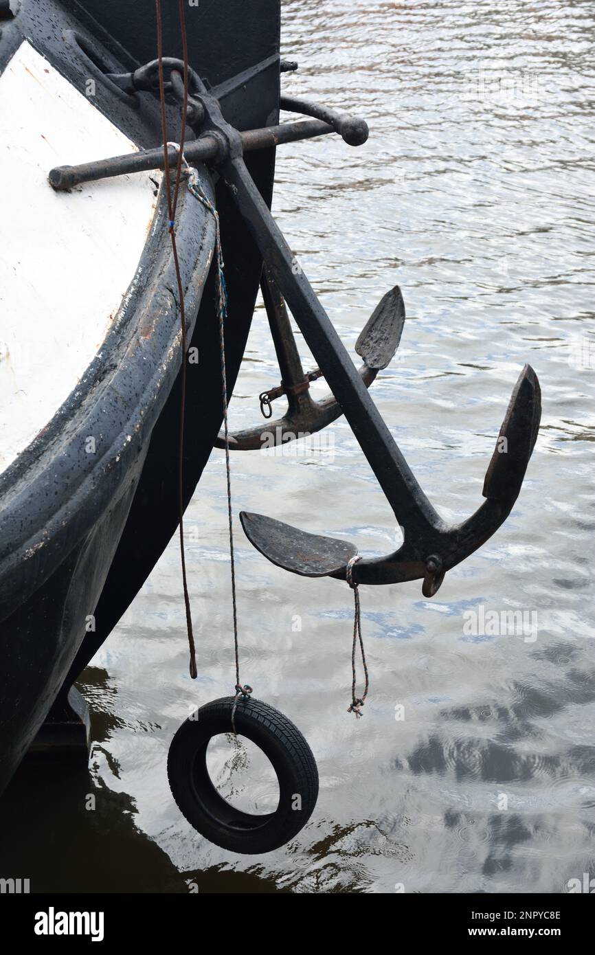 2 anchors hang from the side of a boat Stock Photo - Alamy