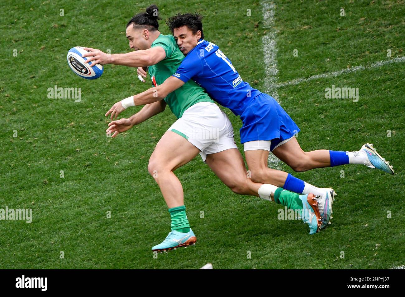 James Lowe of Ireland is tackled by Ange Capuozzo of Italy during the ...