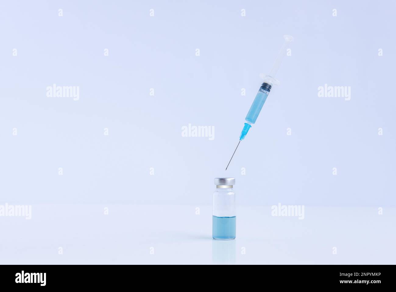 On white isolated background, transparent, glass vial with blue vaccine ...