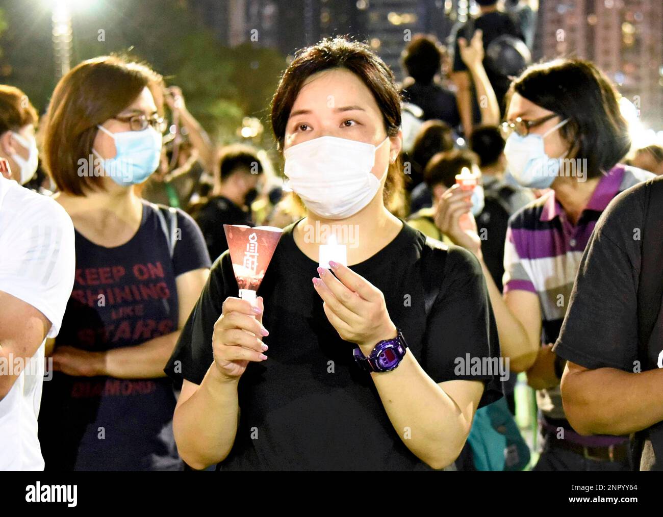 People hold candles to mourn the victims of the 1989 Tiananmen Square ...