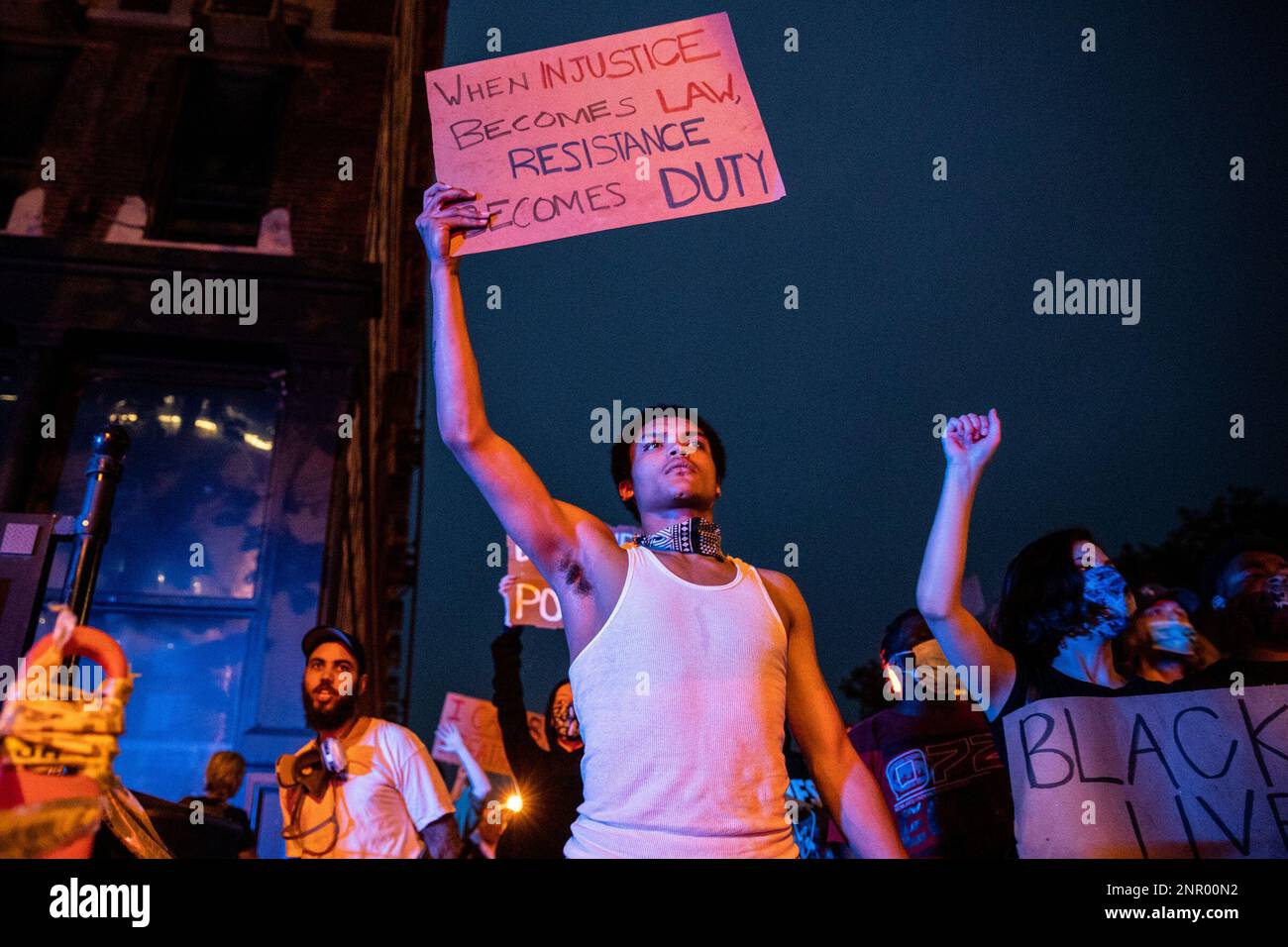 Tyreece Johnson, of Omaha, Neb., and dozens of other people march from ...