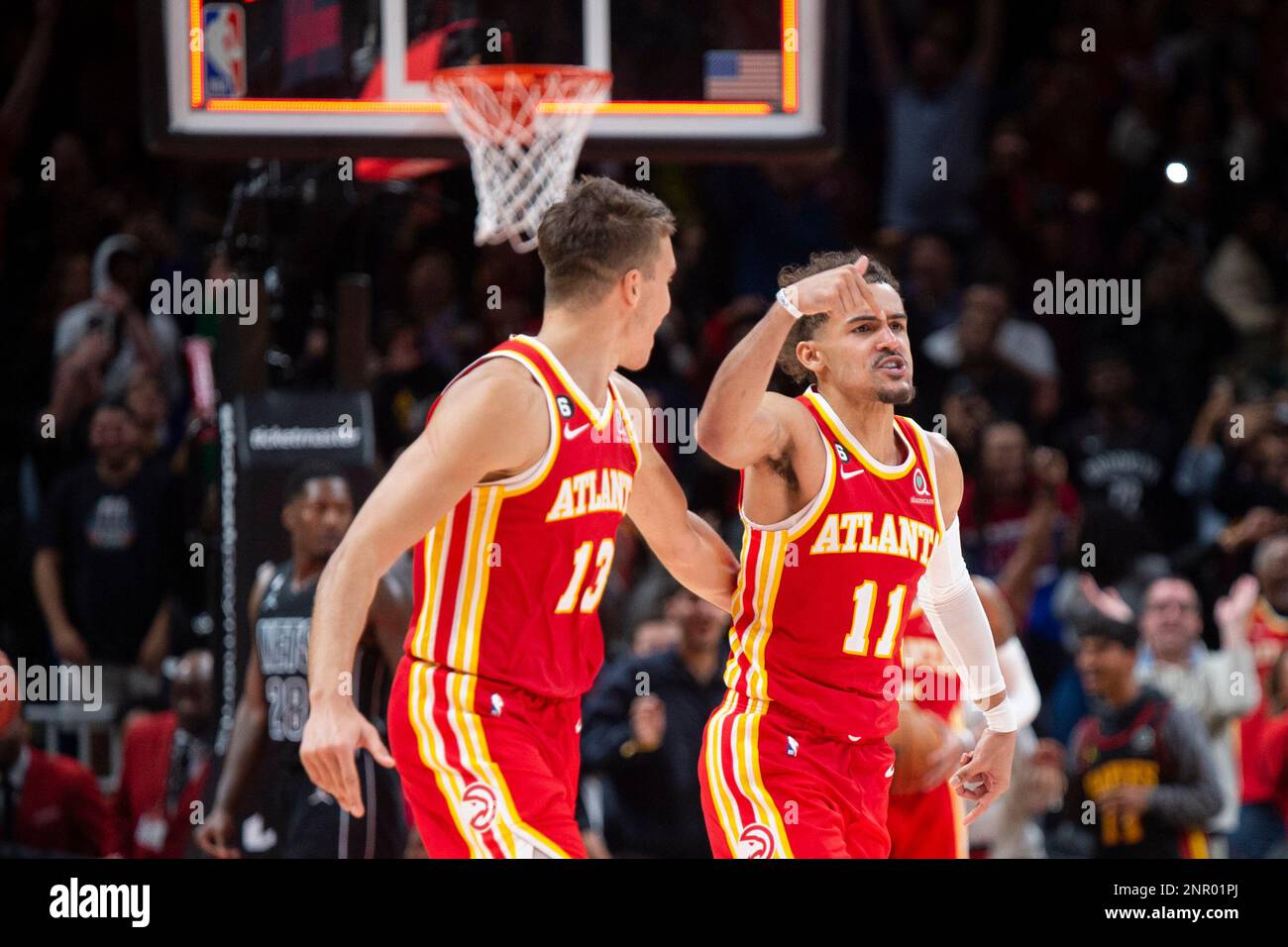 Atlanta Hawks guard Bogdan Bogdanovic, left, and guard Trae Young react ...