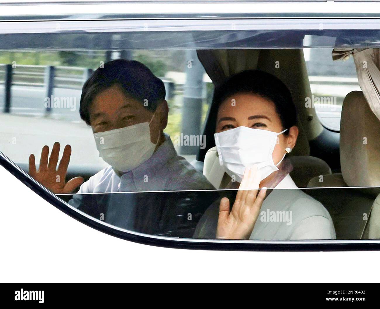 Japan's Emperor Naruhito and Empress Masako wearing masks enter ...