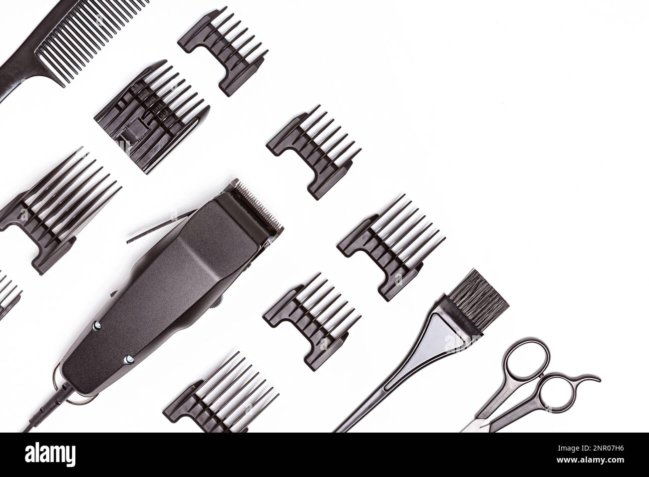 Professional hair clipper with set of nozzles of different sizes ...