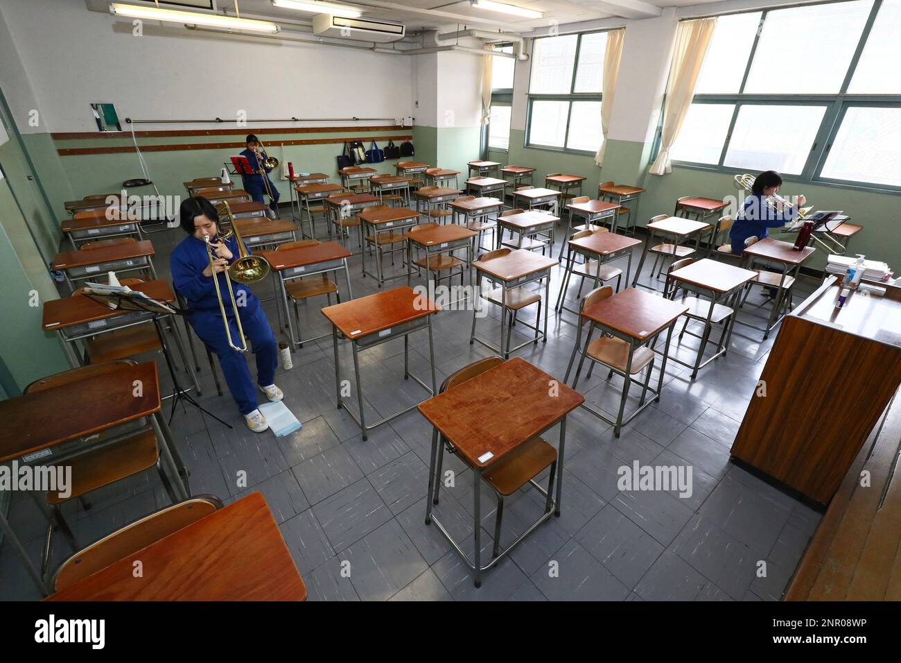 Brass band club students taking spaces practice in small groups at ...