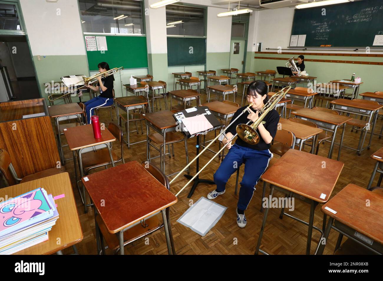 Brass band club students taking spaces practice in small groups at ...
