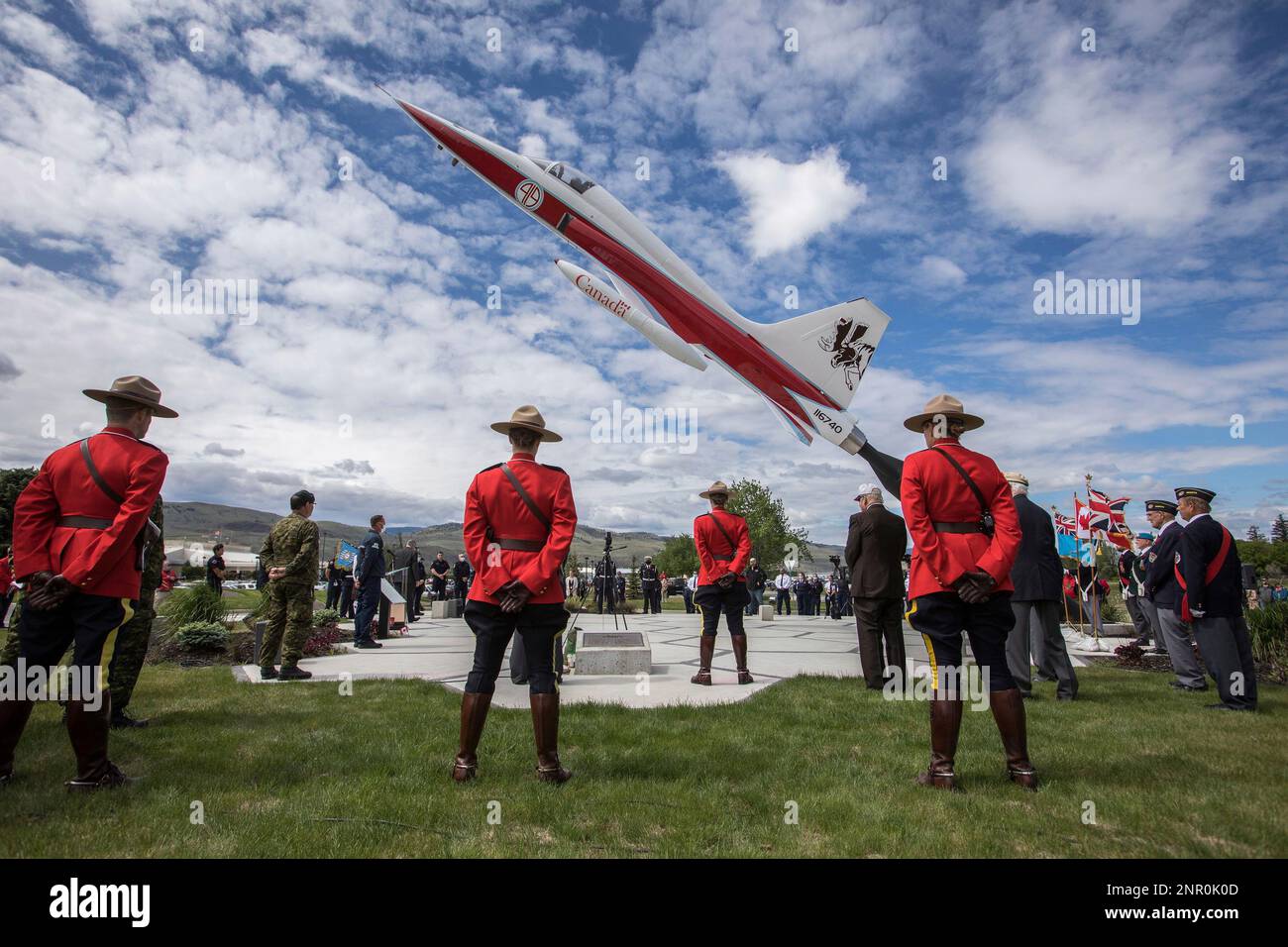 Kamloops RCMP officers stand during a minute of silence during a ...