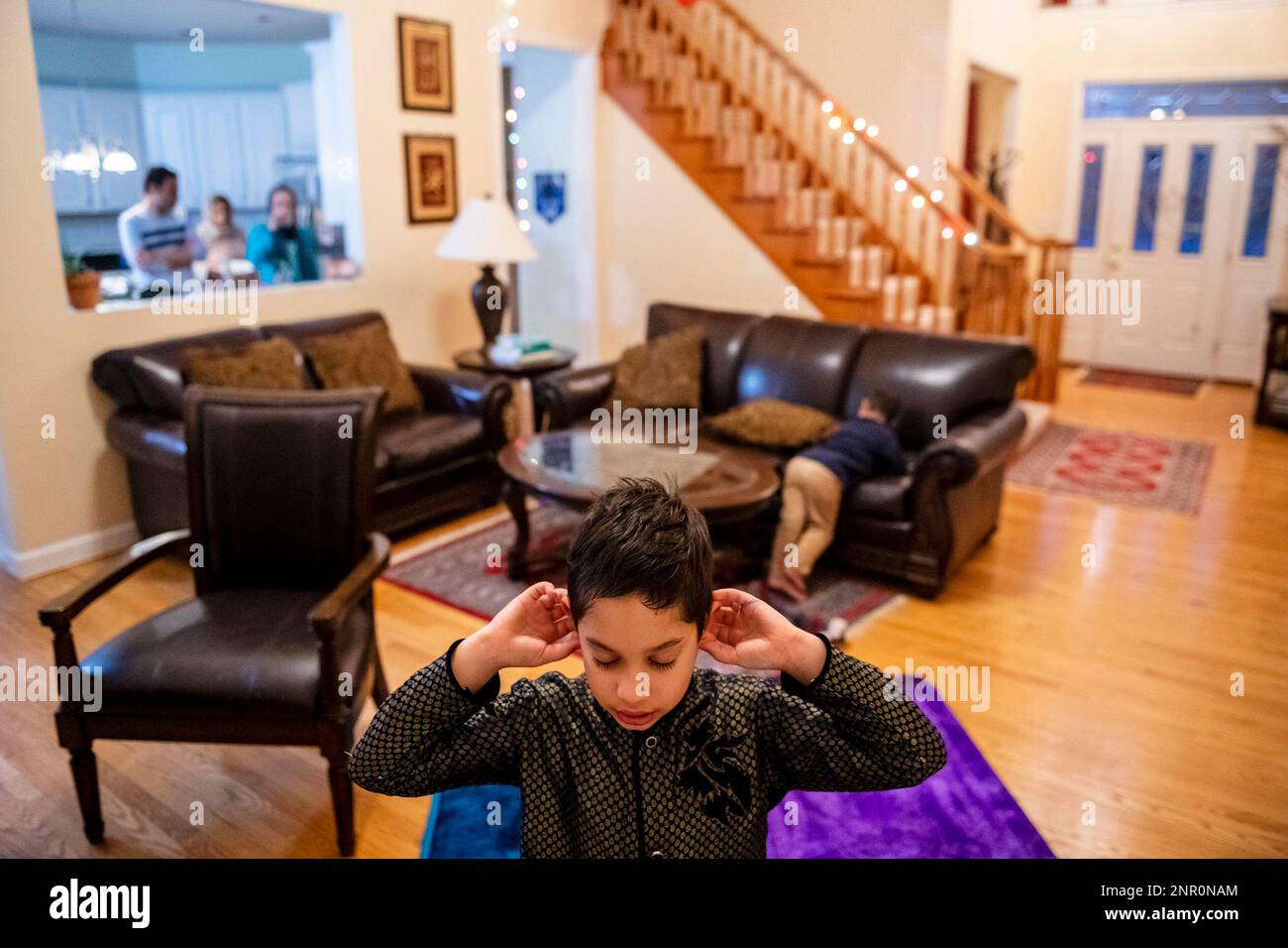 Hamza Ashfaq, 8, of Center Township, serves as the muezzin and says the ...
