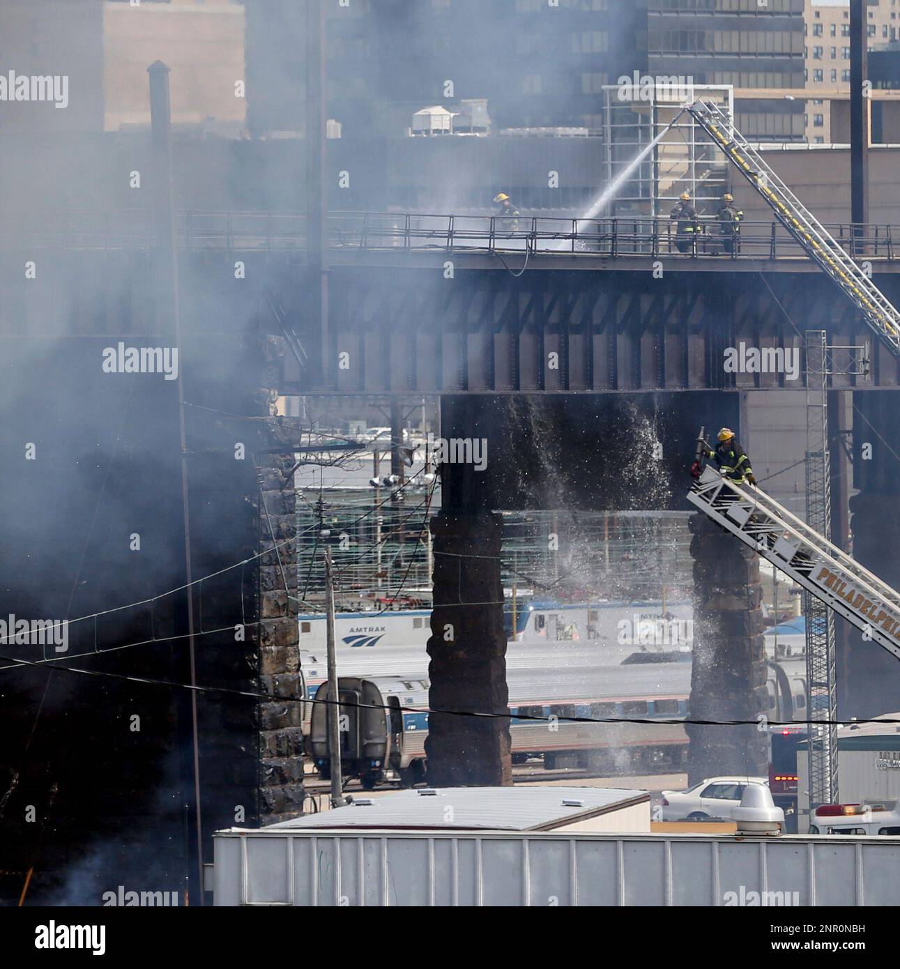 The Philadelphia Fire Department battles a fire on the railroad trestle ...