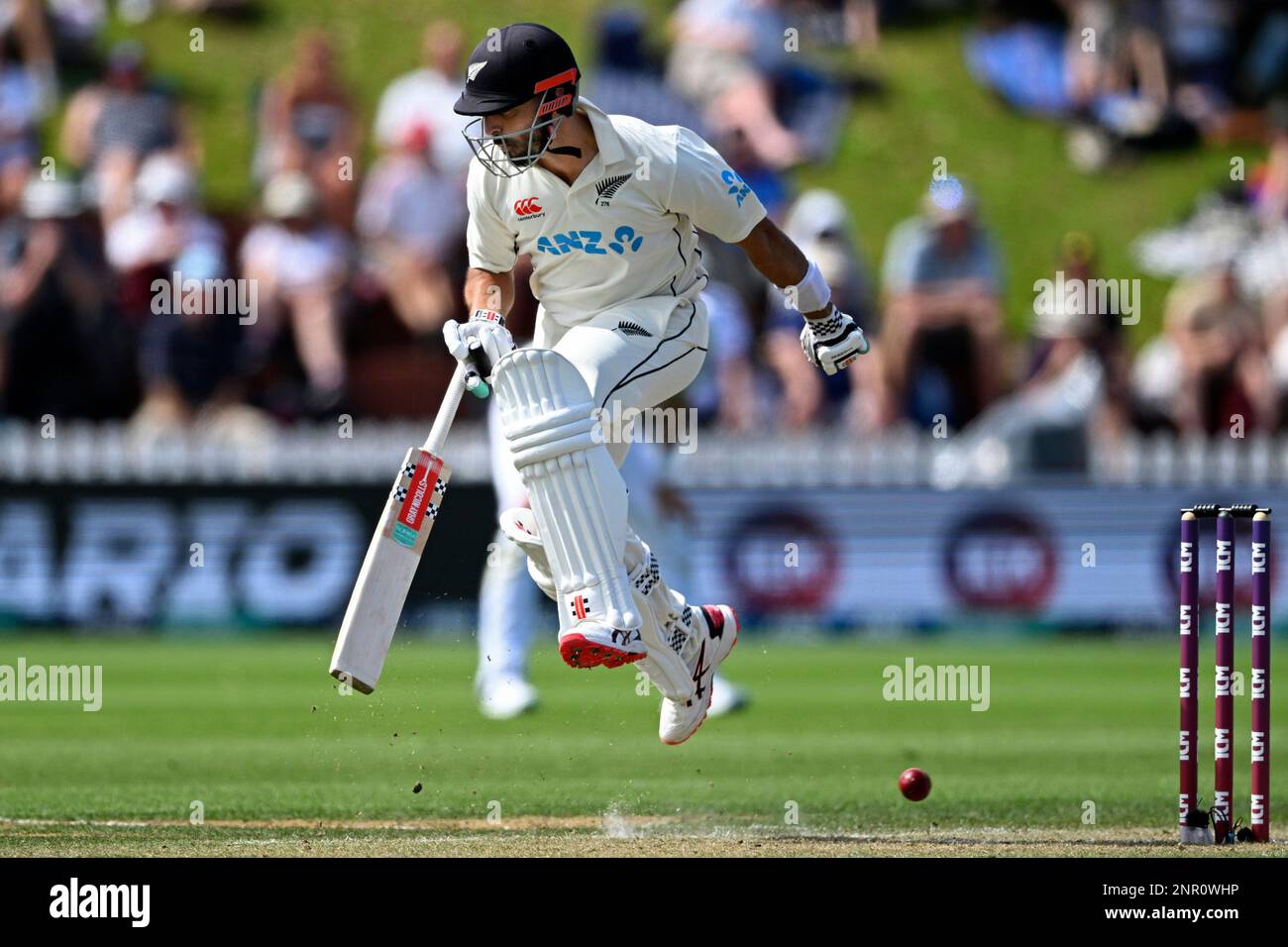 New Zealand's Daryl Mitchell leaps to avoid a thrown ball as he bats ...