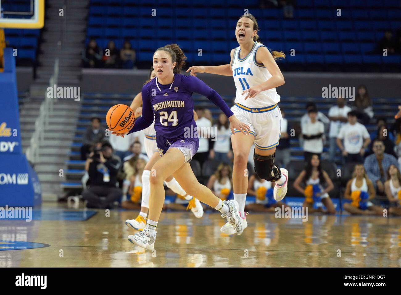 Washington Huskies guard Ellie Ladine (24) dribbles the ball pursued by ...