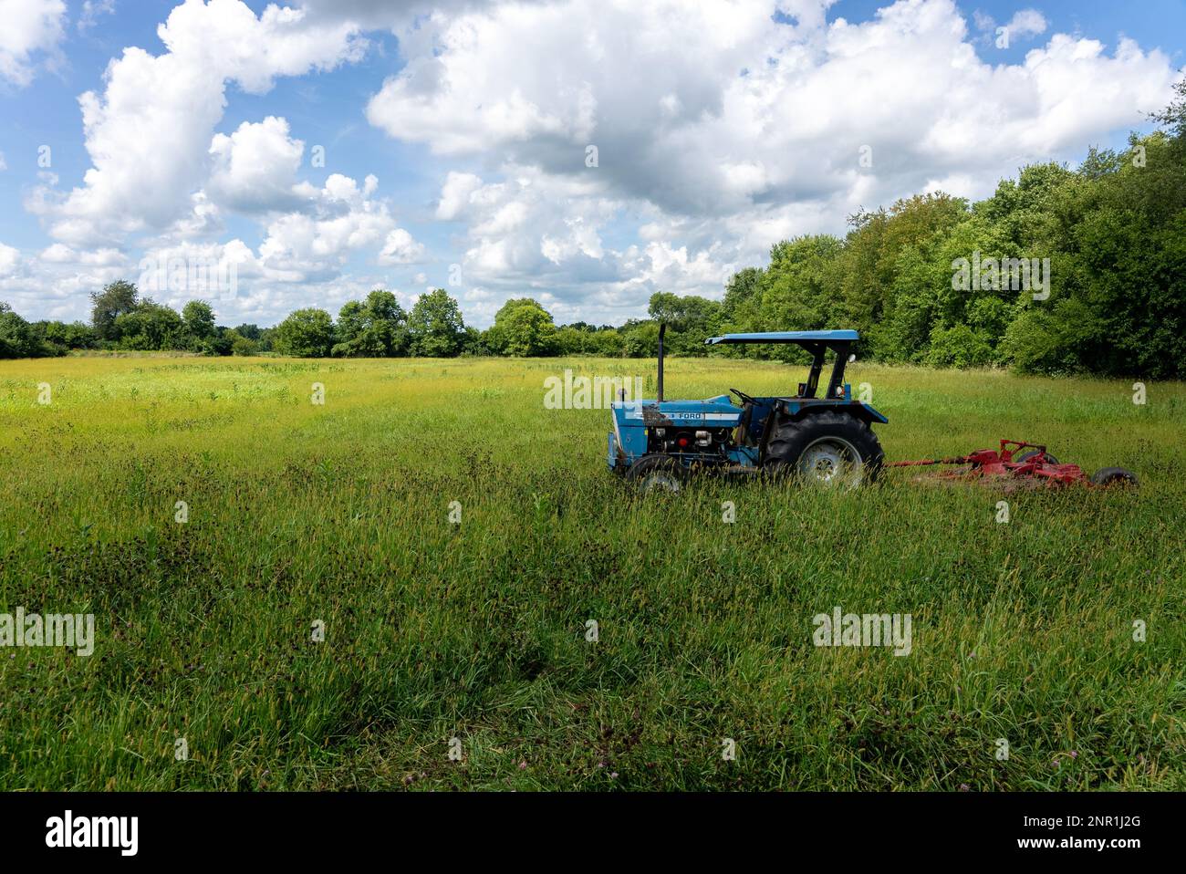 Farm Tractor in Field Stock Photo - Alamy